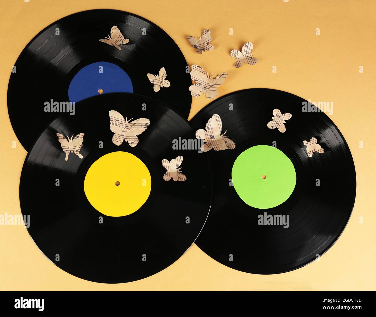 Old vinyl records with paper butterflies, on brown background Stock ...