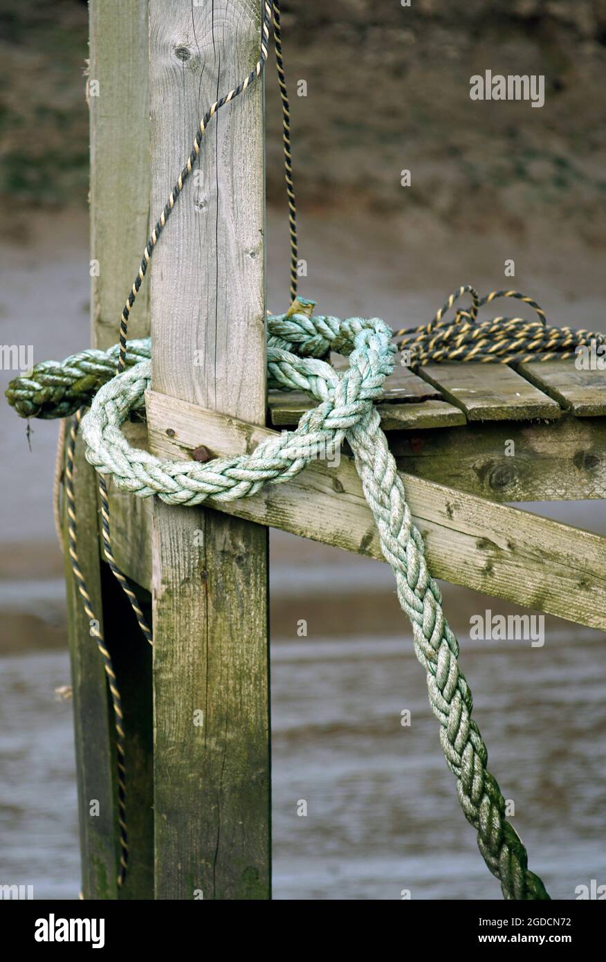 wooden mooring staging and plaited rope Stock Photo - Alamy
