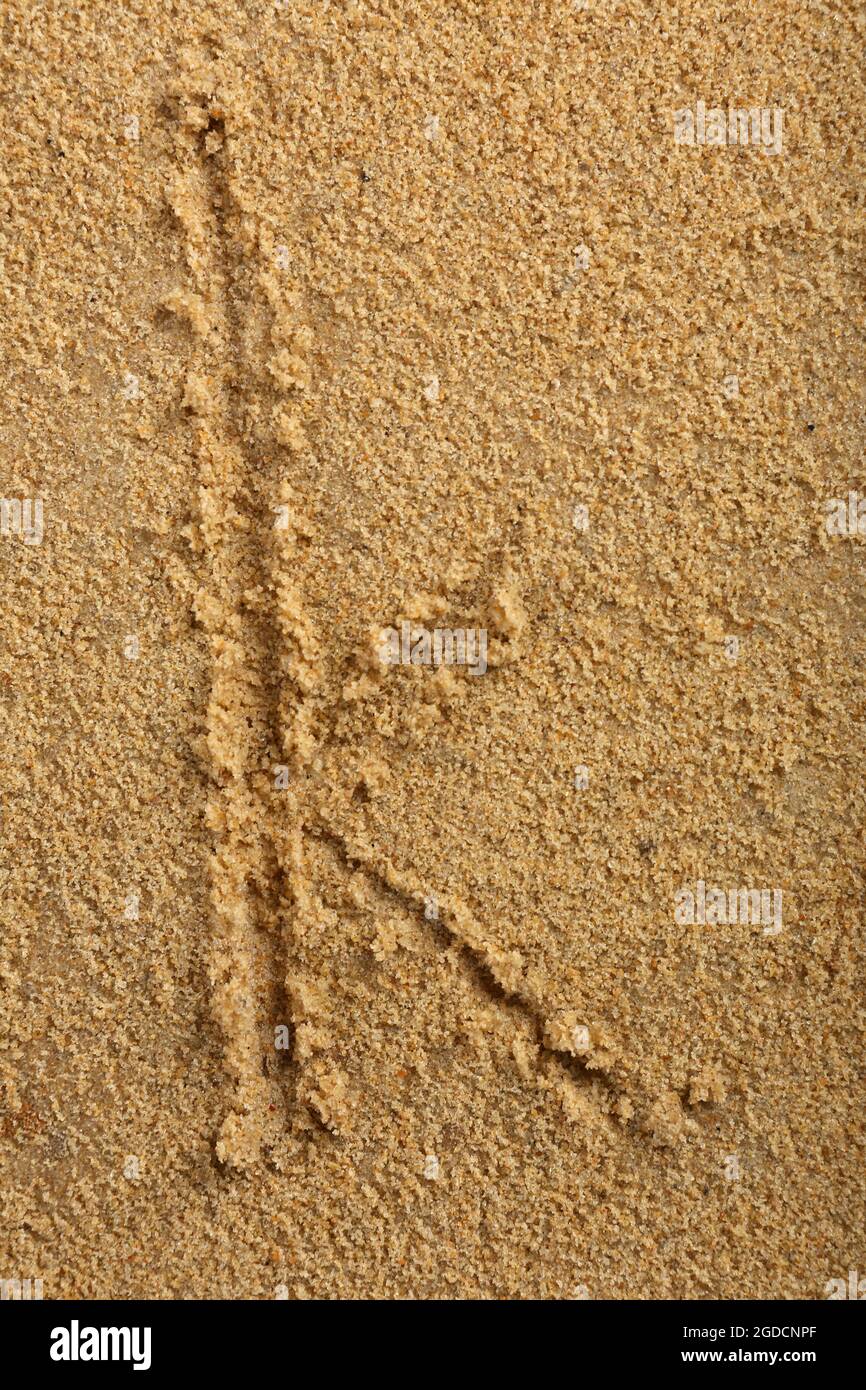 Alphabet letter written on wet beach sand Stock Photo - Alamy
