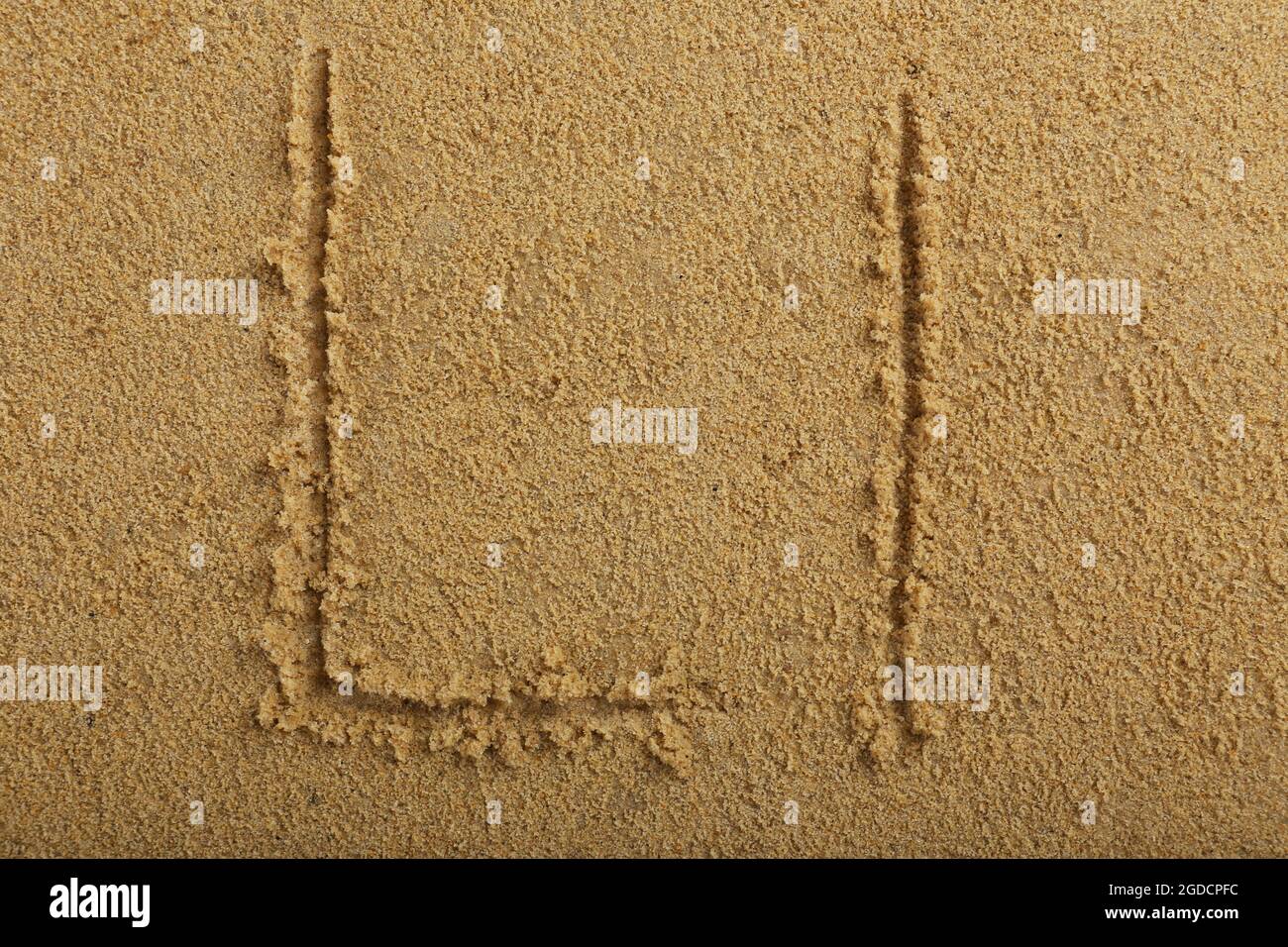 Alphabet letter written on wet beach sand Stock Photo - Alamy