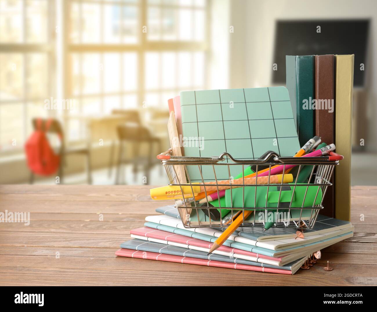 School supplies on desk in classroom Stock Photo - Alamy