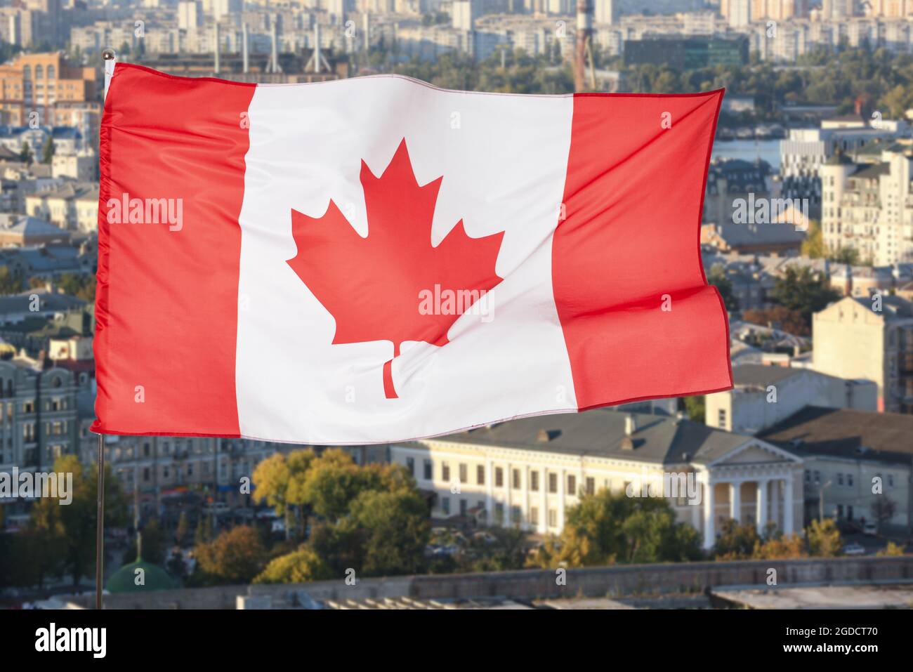 National flag of Canada in modern city Stock Photo - Alamy