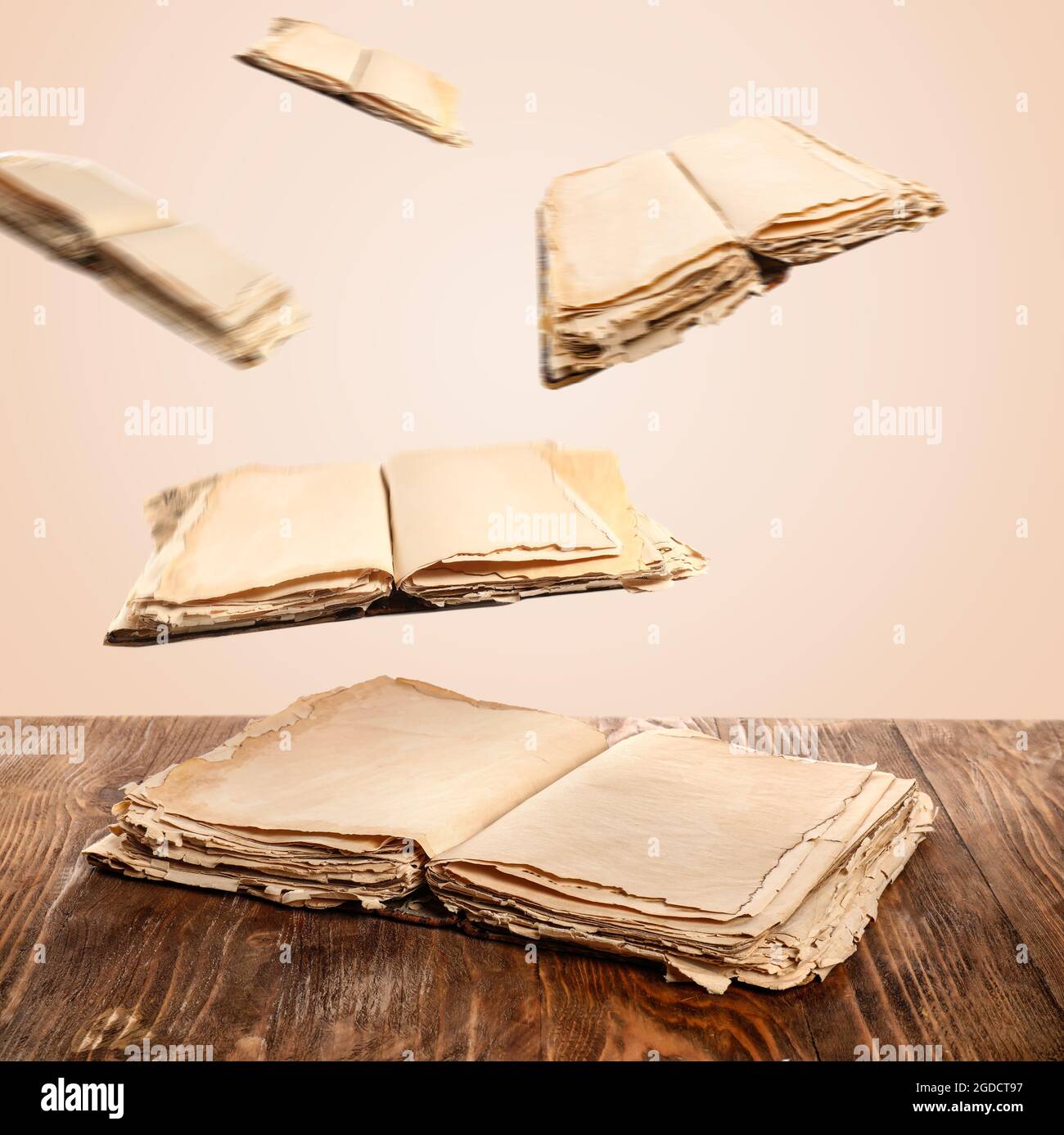 Flying old books on light background Stock Photo - Alamy