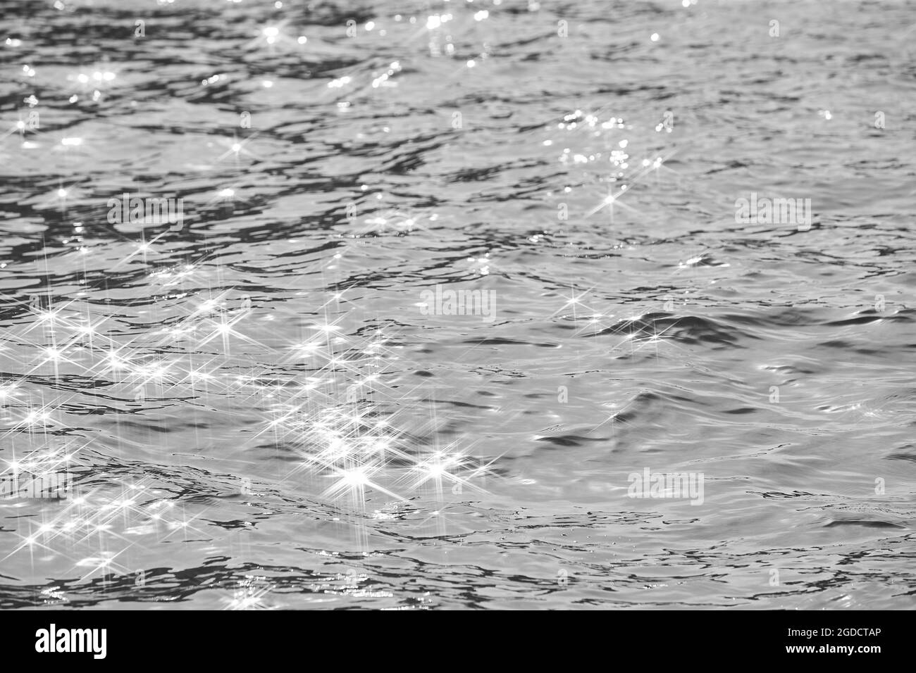 Detail of a sunlight reflecting in glittering sea. sparkler in water ...