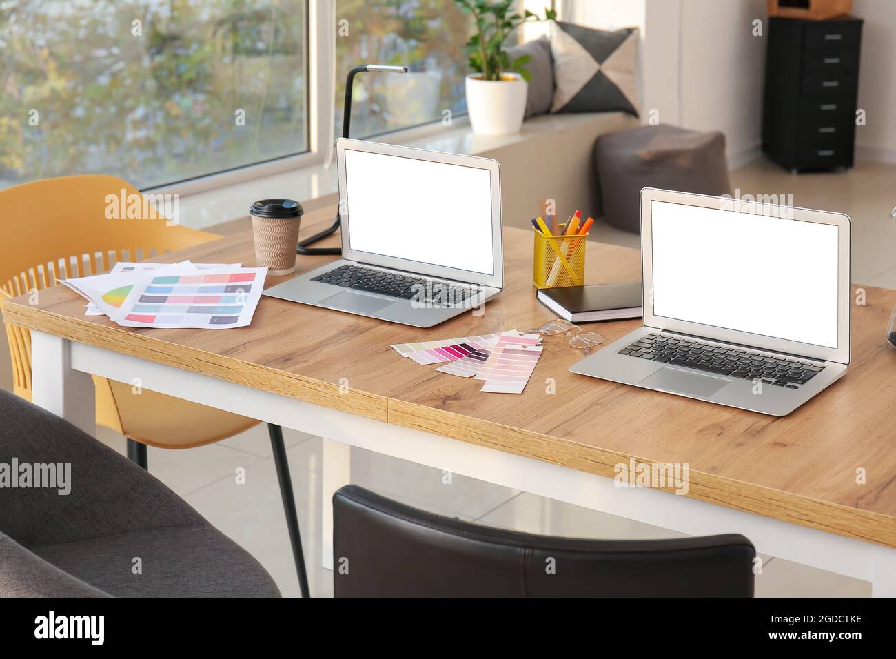 Stylish workplace of graphic designers with laptops in office Stock ...