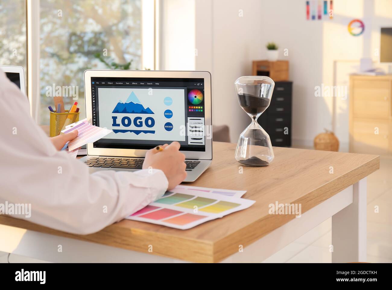 Graphic designer working in office Stock Photo - Alamy