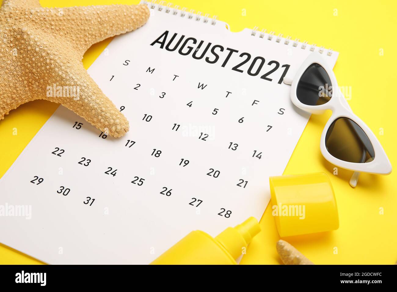 Calendar with beach accessories on color background, closeup Stock ...