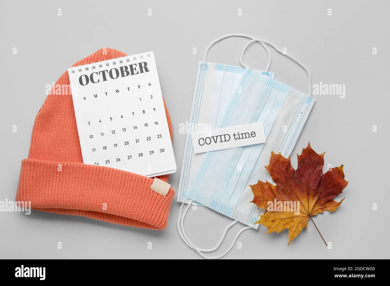Calendar with hat and medical masks on light background Stock Photo - Alamy