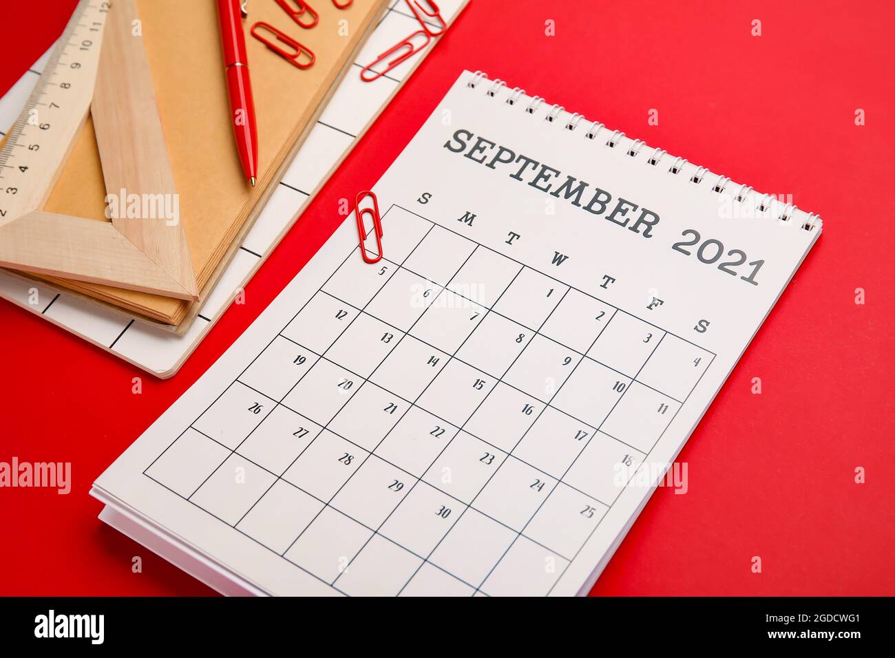 Calendar with notebook and stationery on color background, closeup ...