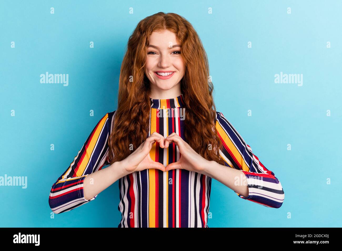 Photo of funky ginger hairdo millennial lady show heart wear colorful ...