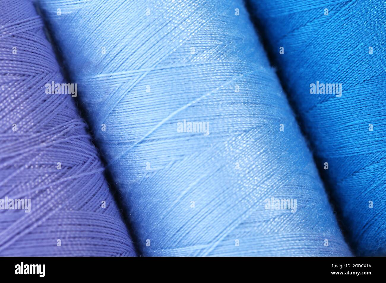 Colorful sewing threads background Stock Photo - Alamy