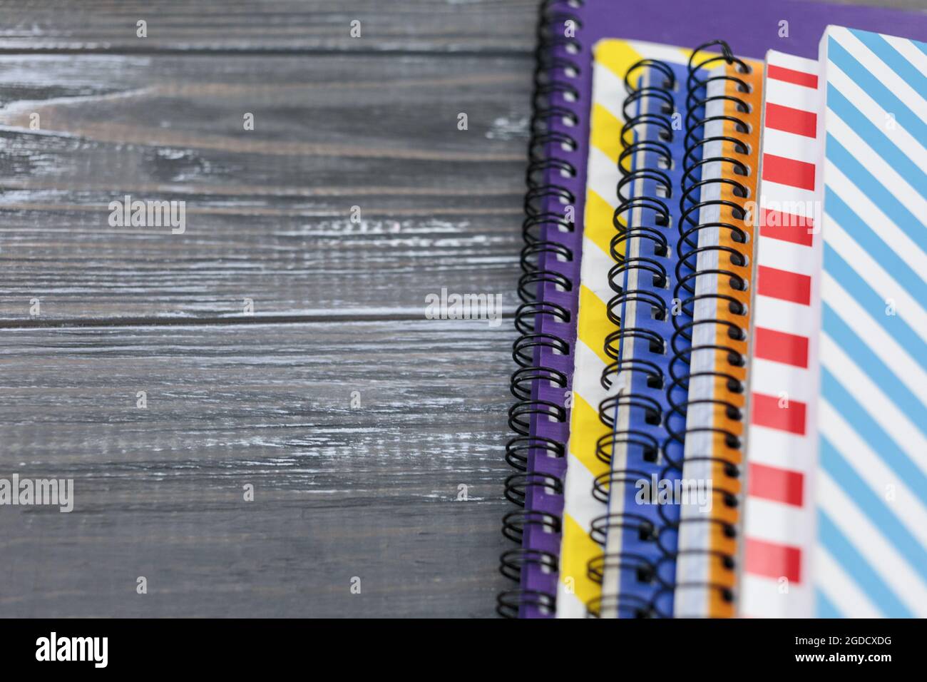Set of colored notebooks on gray wooden table. Back to school ...