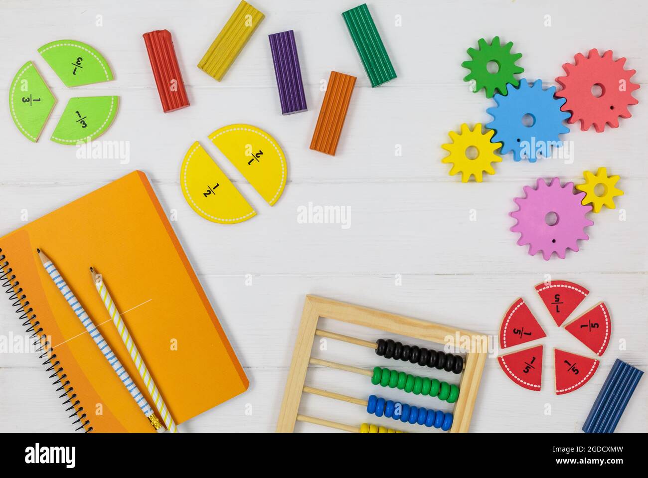 Multicolored fractions, blocks, notebook on white wooden table. Back to ...