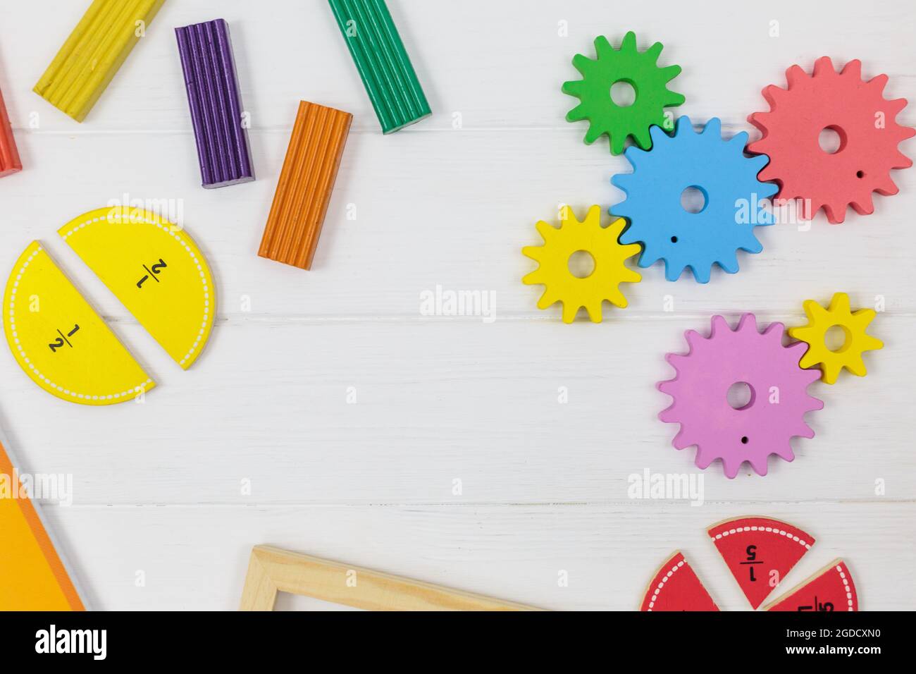 Multicolored fractions, blocks, notebook on white wooden table. Back to ...