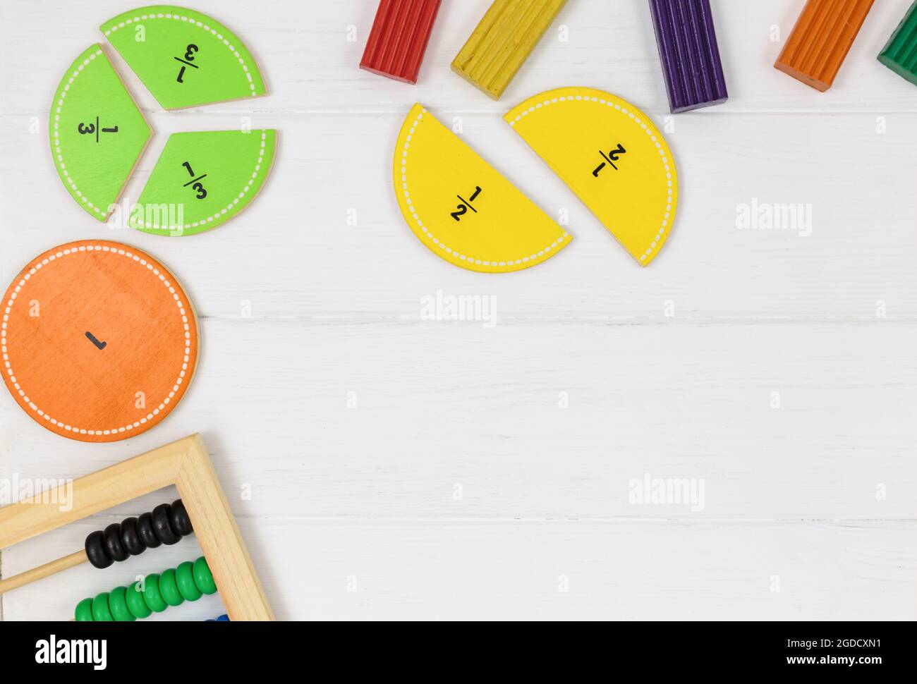 Multicolored fractions, blocks, notebook on white wooden table. Back to ...