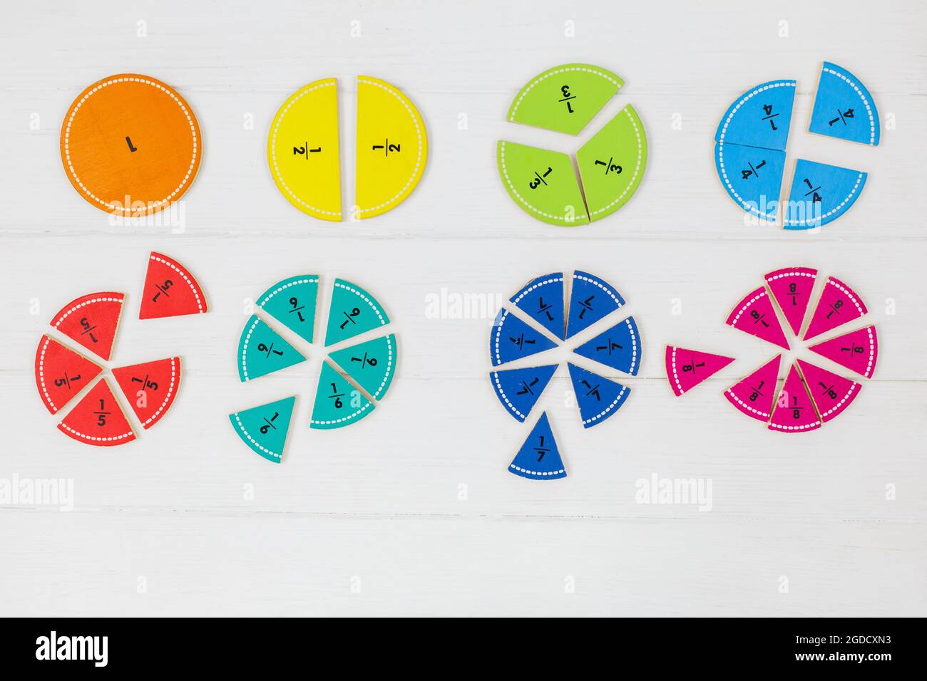 Multicolored fractions, blocks, notebook on white wooden table. Back to ...