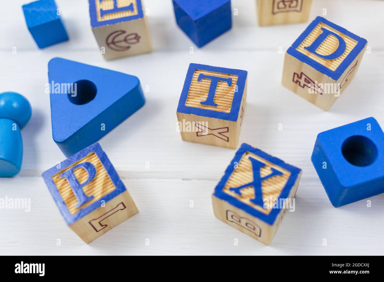 Blue wooden alphabet blocks on a white wooden table. Back to school ...