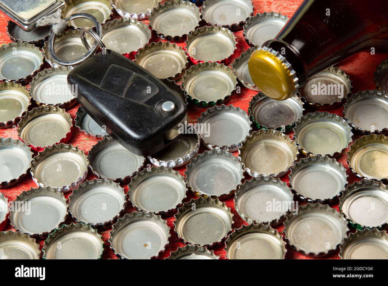 alcohol abuse and danger in car driving symbolized by key and bottle ...