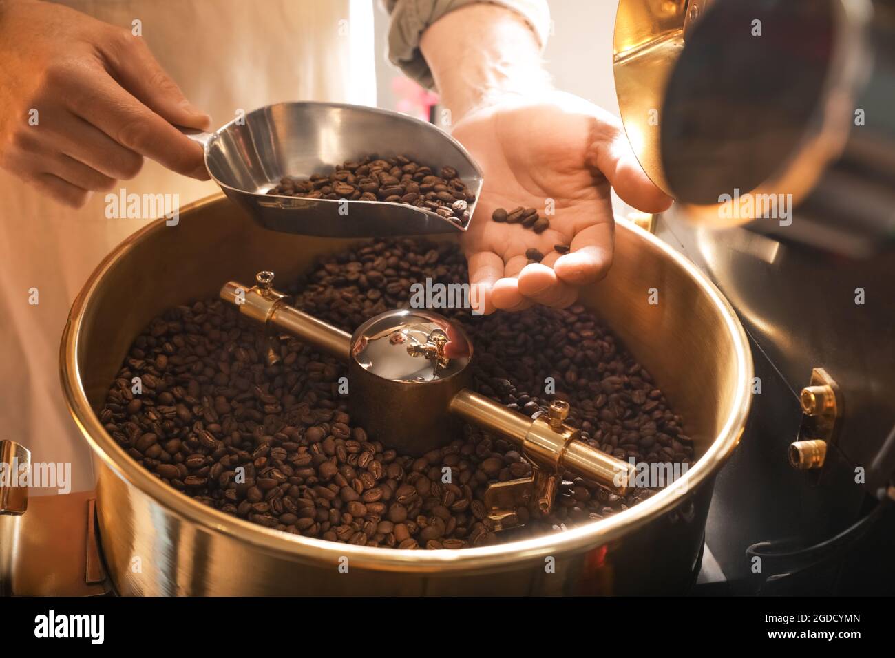Senior man using modern coffee roaster, closeup Stock Photo - Alamy