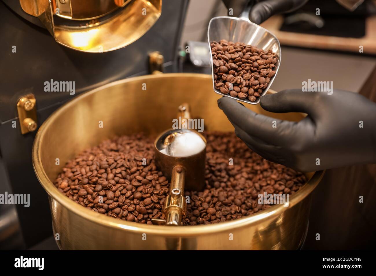 Man using modern coffee roaster, closeup Stock Photo - Alamy