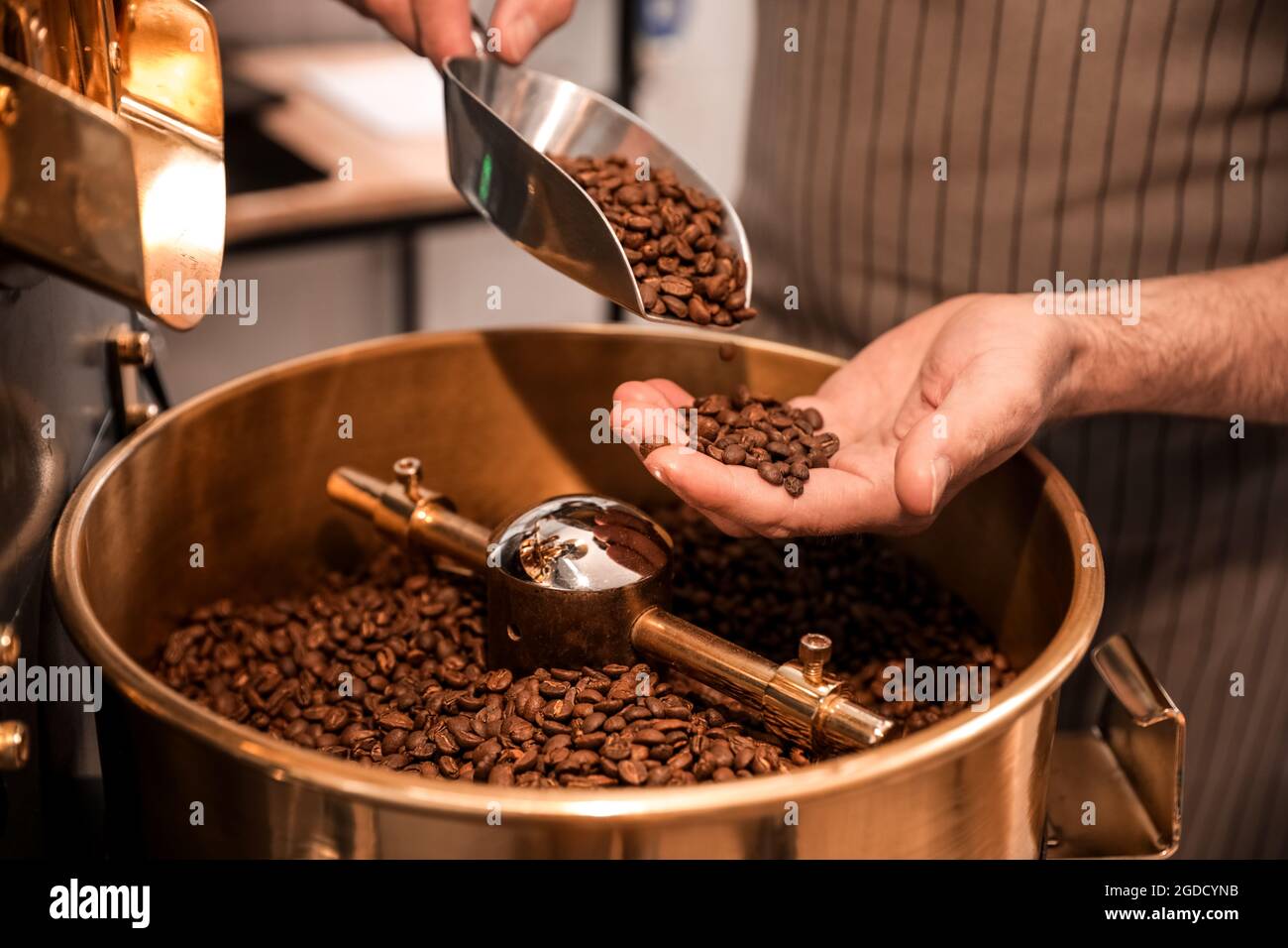 Senior man using modern coffee roaster, closeup Stock Photo - Alamy