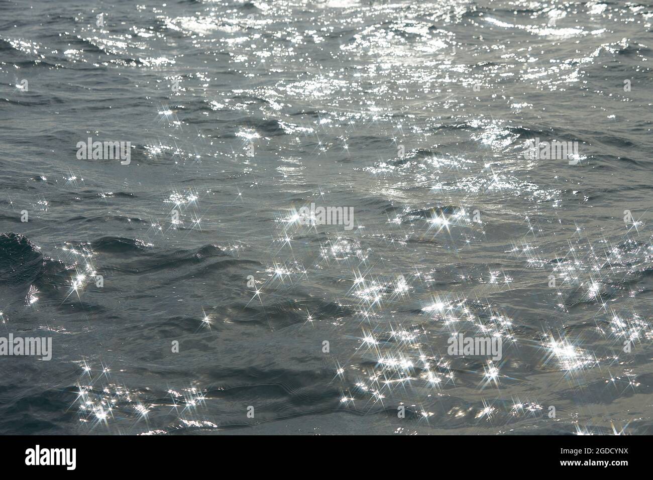 Detail of a sunlight reflecting in glittering sea. sparkler in water ...