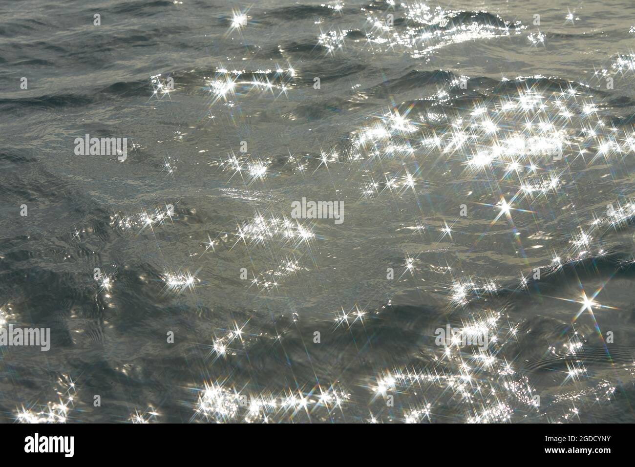 Detail of a sunlight reflecting in glittering sea. sparkler in water ...