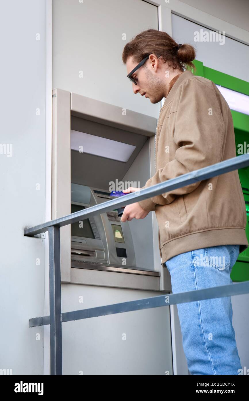 Man withdrawing money from ATM Stock Photo - Alamy