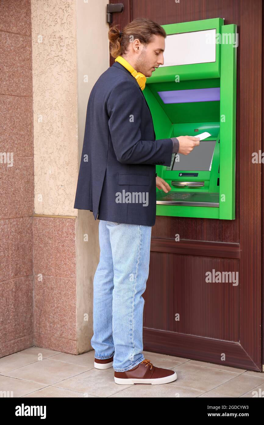 Man withdrawing money from ATM Stock Photo - Alamy