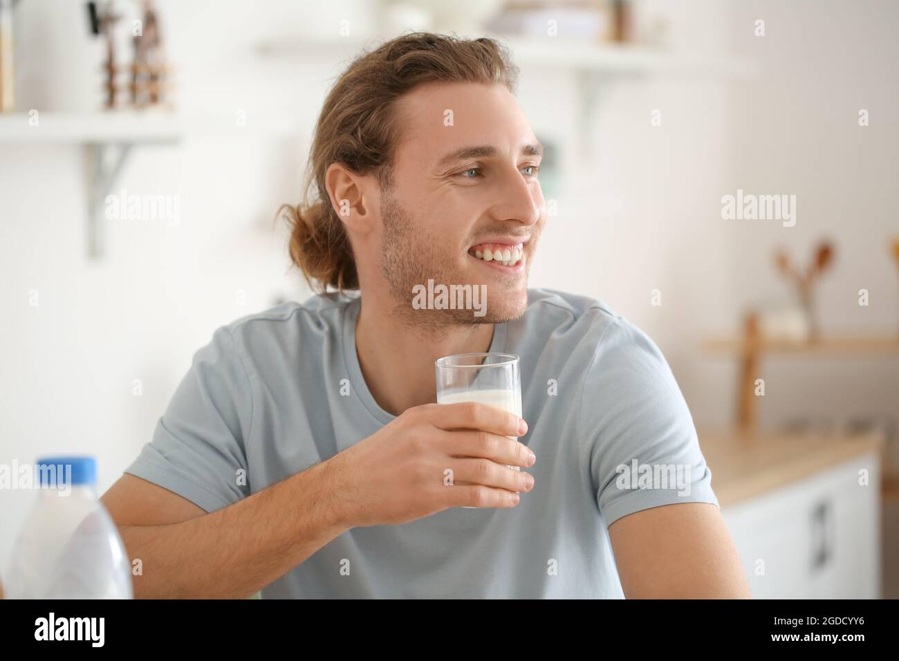 Young man drinking fresh milk at home Stock Photo - Alamy