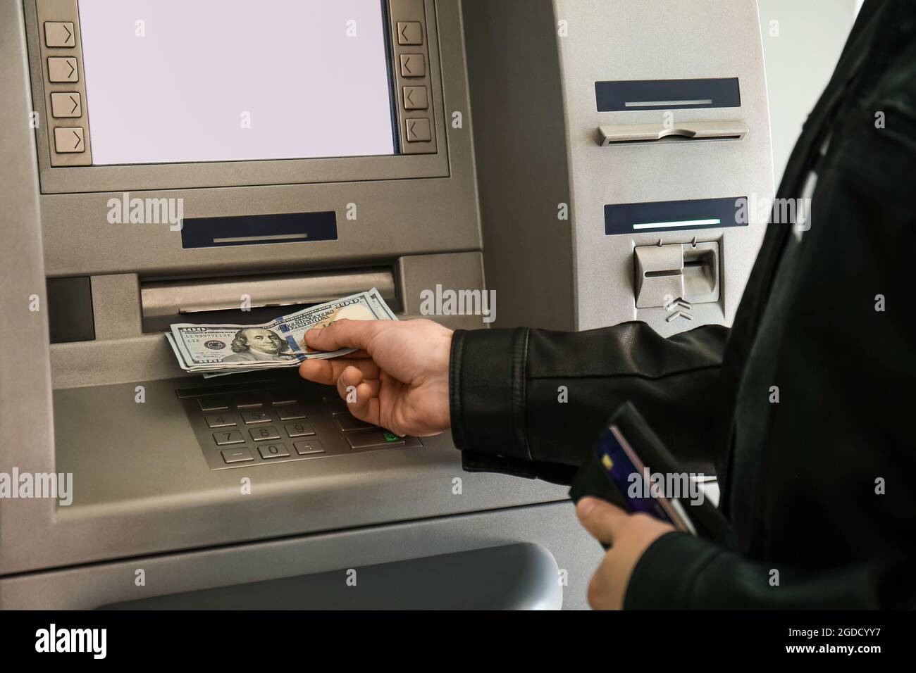 Man withdrawing money from ATM Stock Photo - Alamy