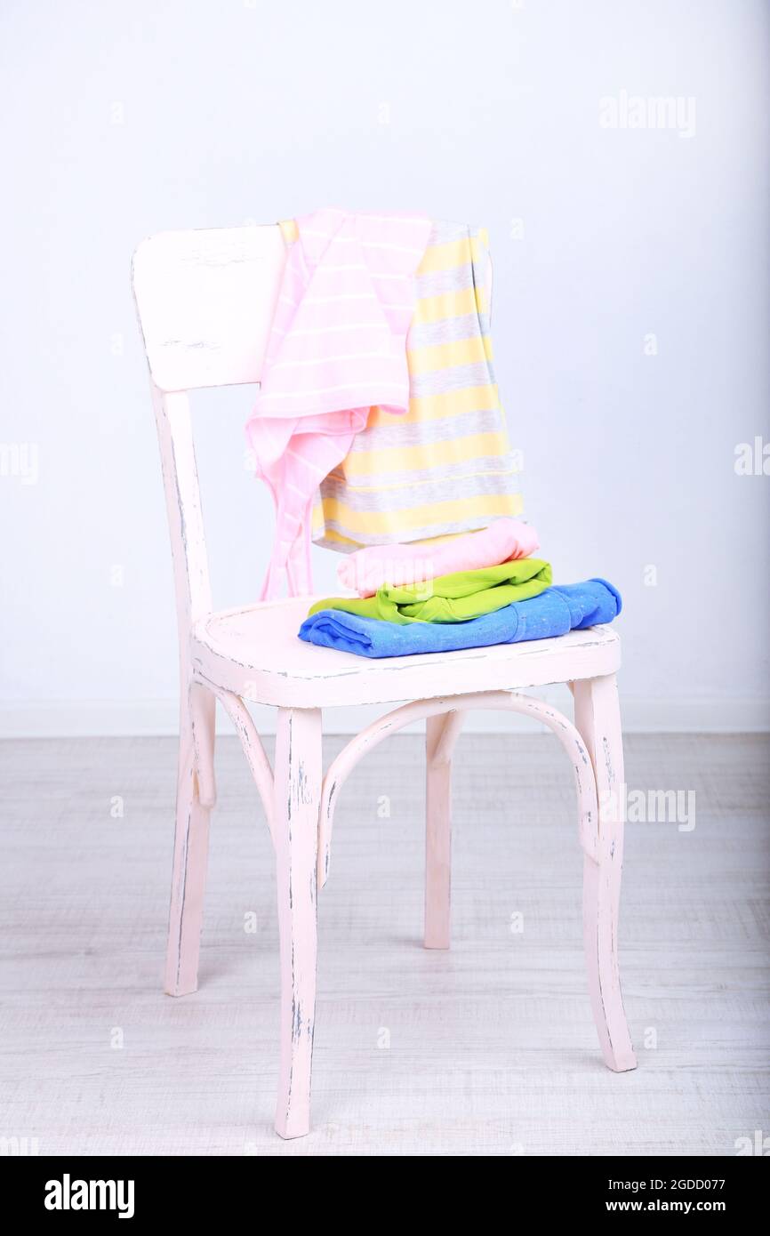 Clothes on chair on gray background Stock Photo - Alamy