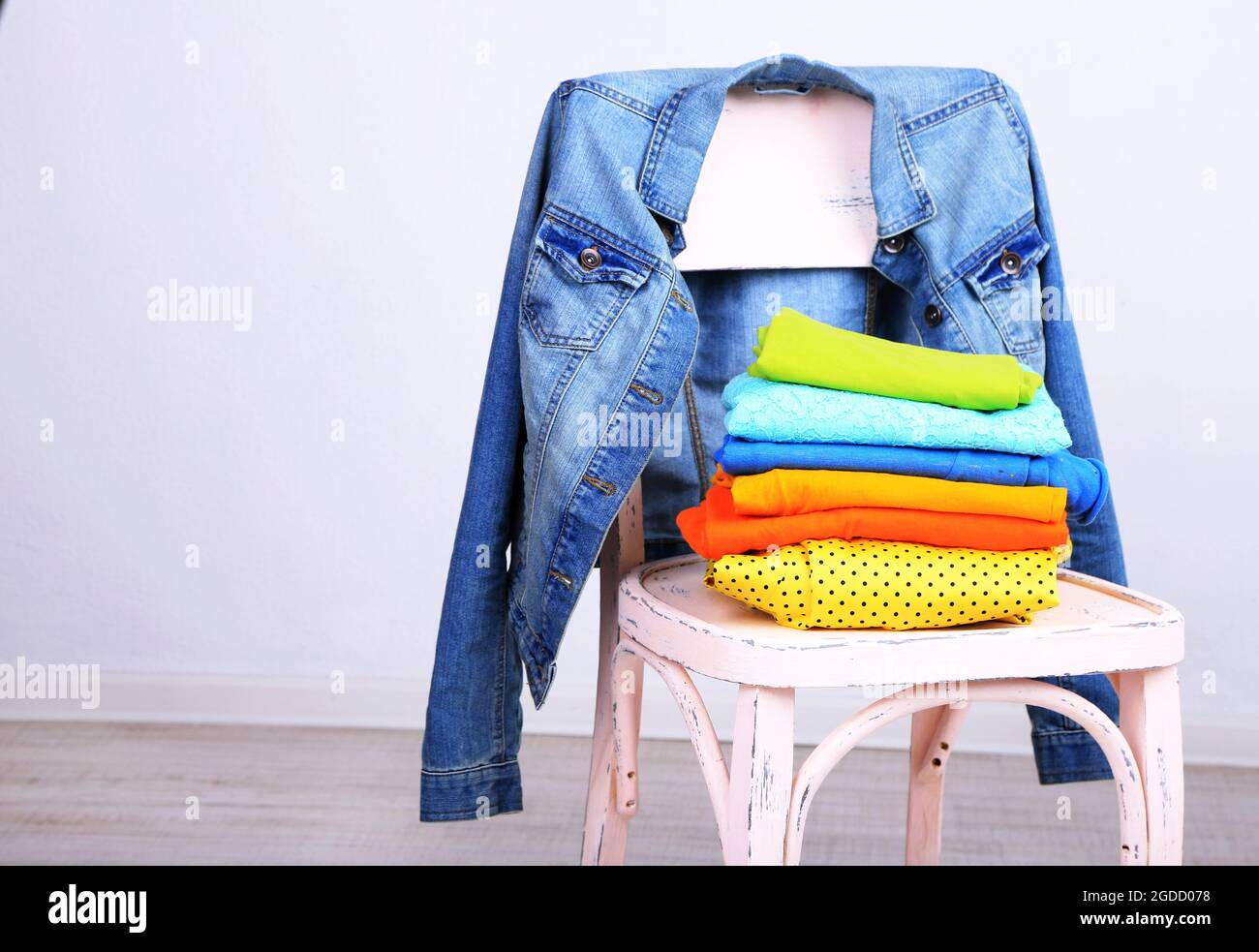Clothes on chair on gray background Stock Photo - Alamy