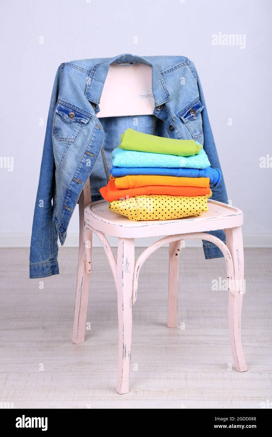 Clothes on chair on gray background Stock Photo - Alamy