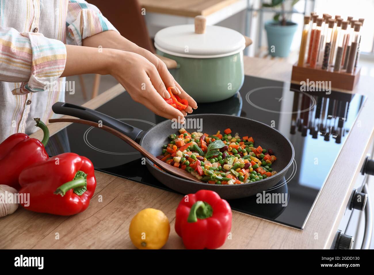 Young woman adding frying hi-res stock photography and images - Alamy