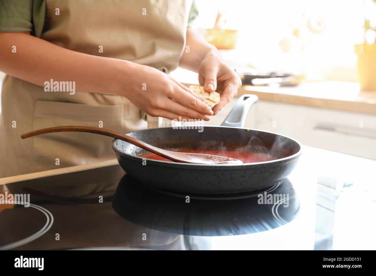 Young woman adding sauce hi-res stock photography and images - Alamy
