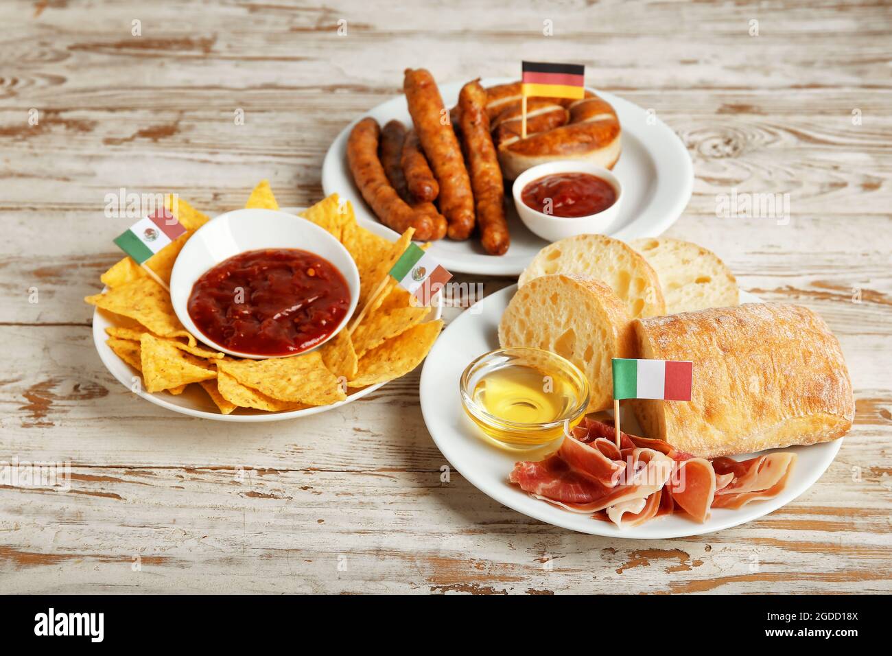 Plates with traditional food of different countries on wooden ...
