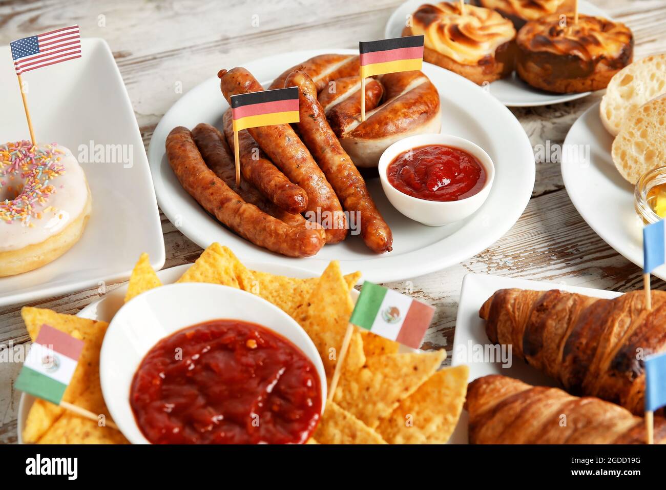 Plates with traditional food of different countries on wooden ...