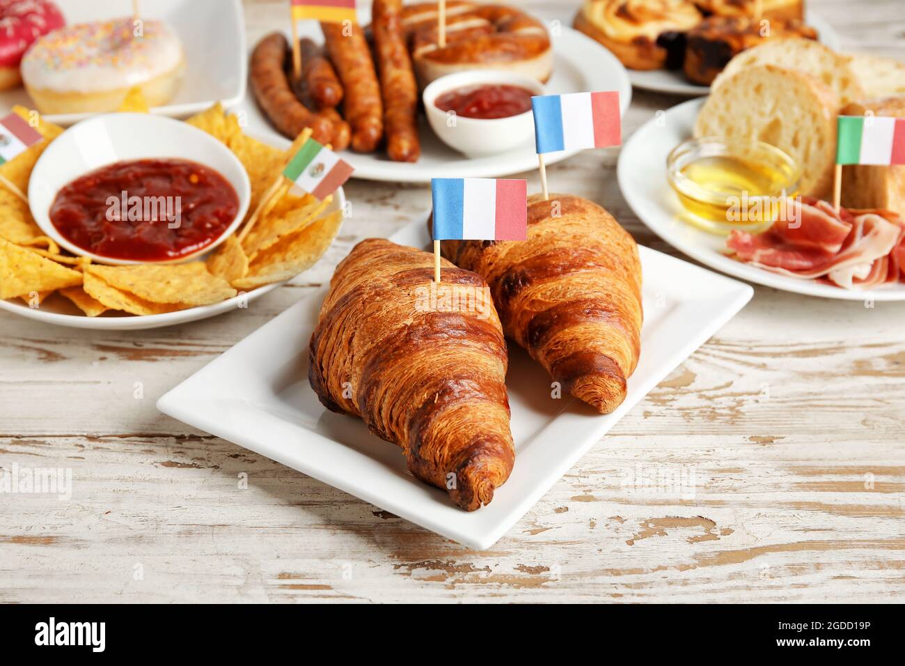 Plates with traditional food of different countries on wooden ...