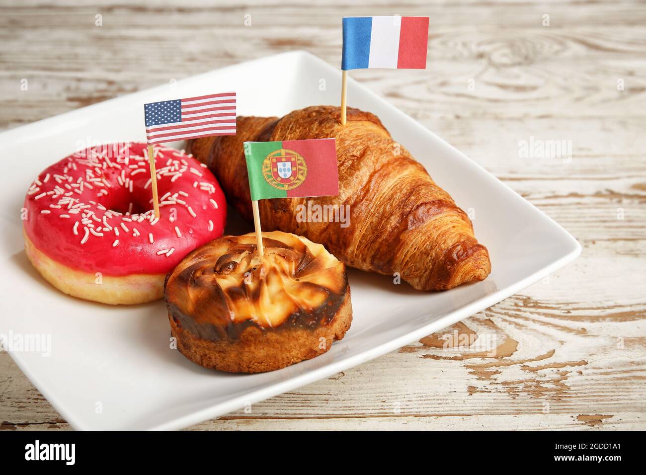 Plate with traditional desserts of different countries on wooden ...
