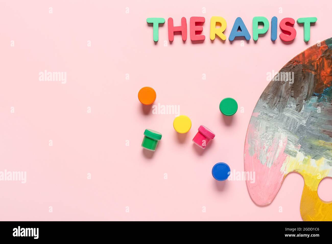 Word THERAPIST with paints and palette on color background Stock Photo ...
