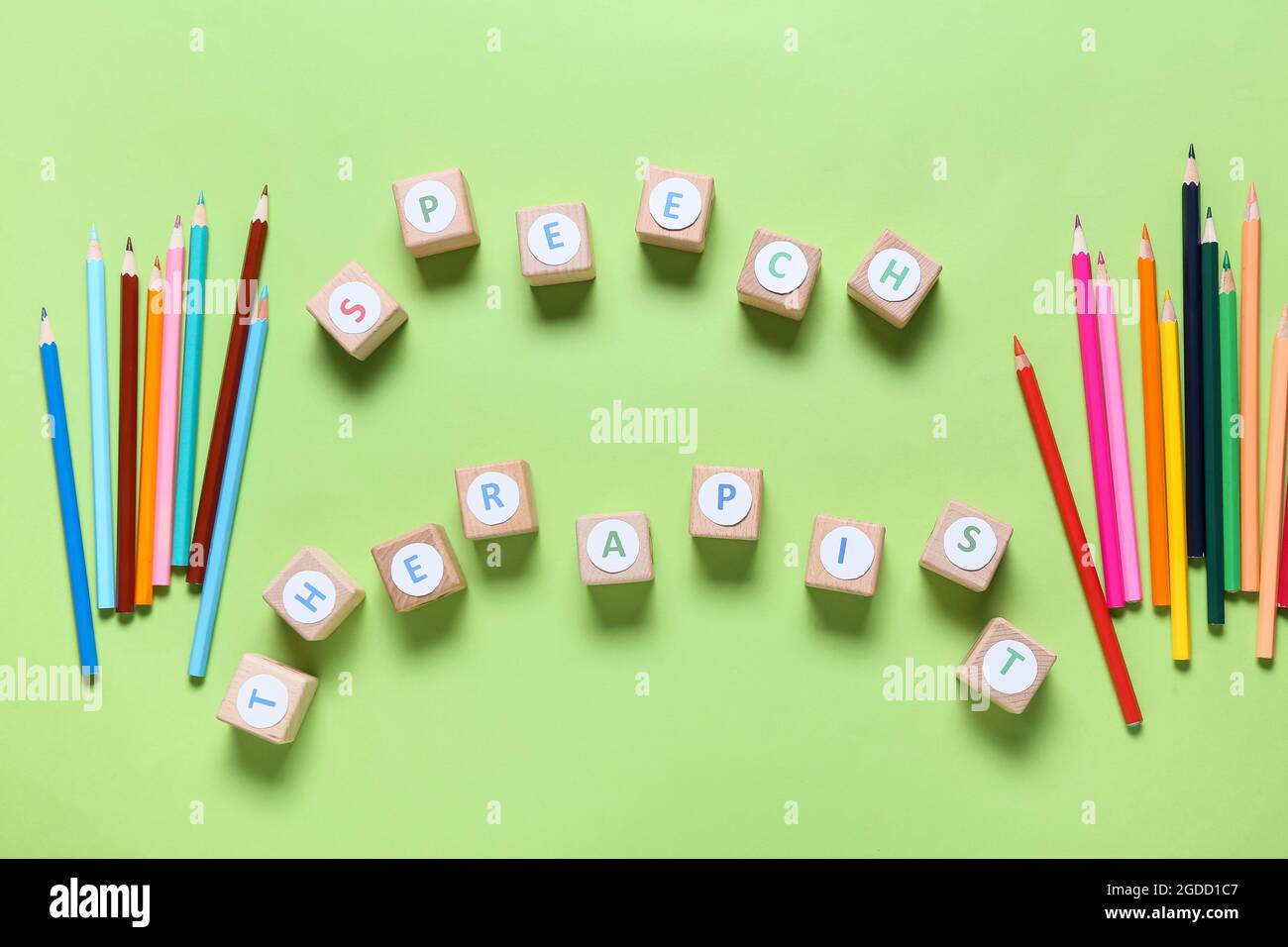 Cubes with text SPEECH THERAPIST and pencils on color background Stock ...