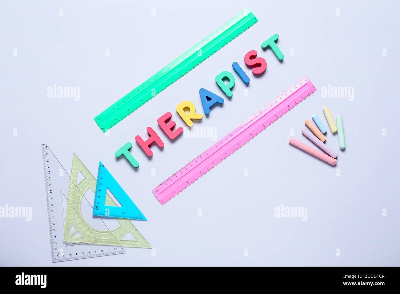 Word THERAPIST with rulers and chalks on light background Stock Photo ...