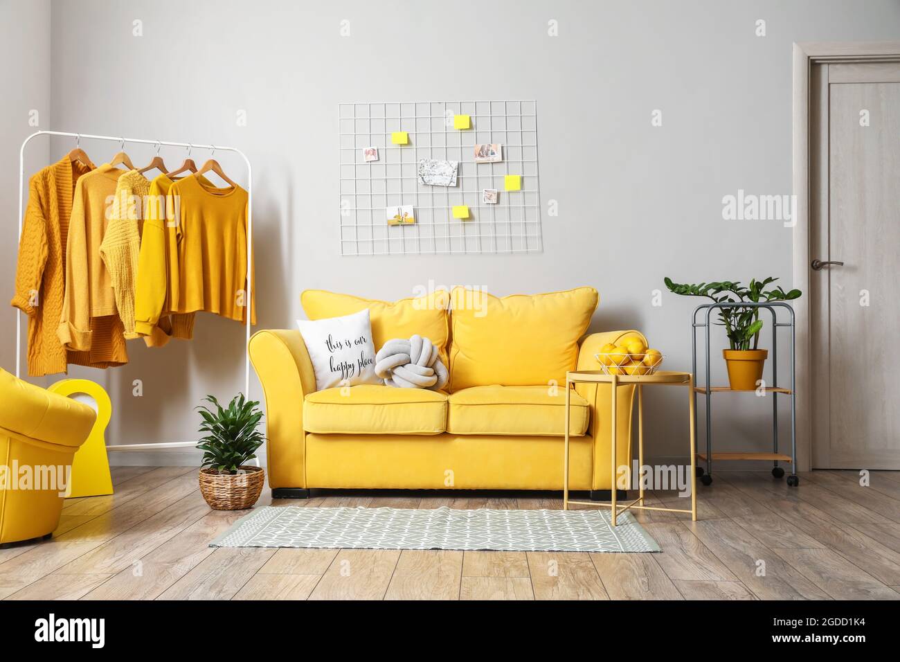 Interior of stylish living room with clothes Stock Photo - Alamy