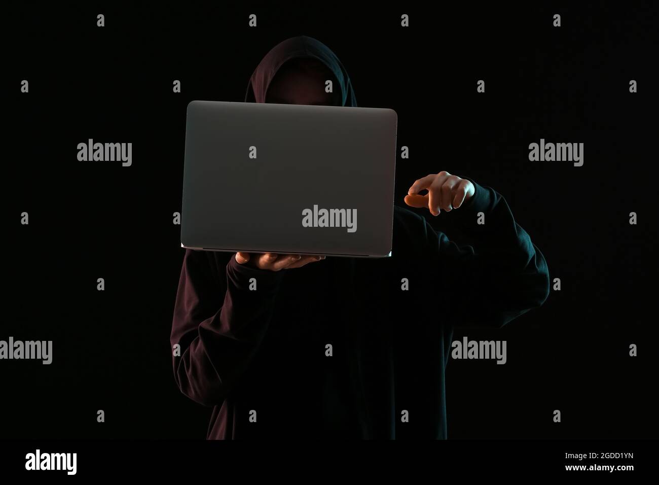 Hacker with laptop on dark background Stock Photo - Alamy