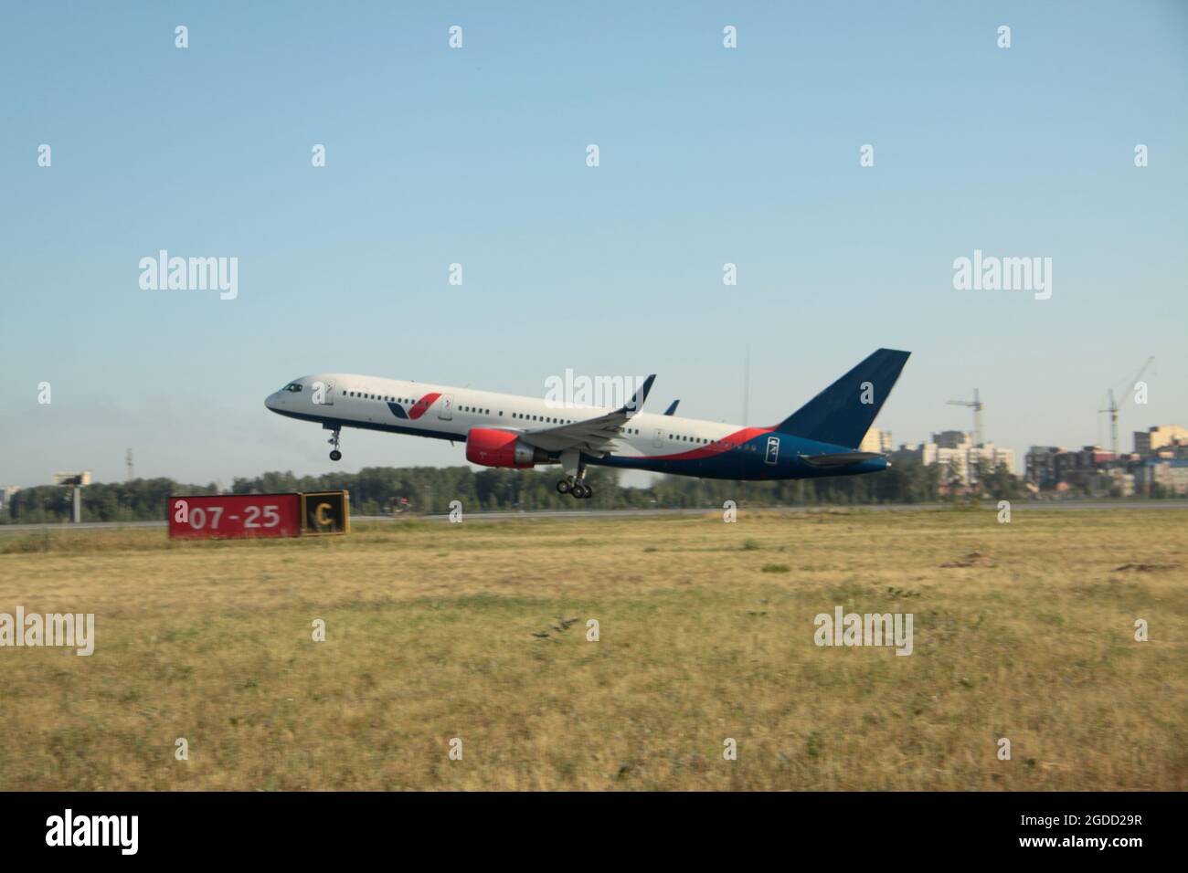 Passenger plane takes off from the airport runway. Side-view of ...