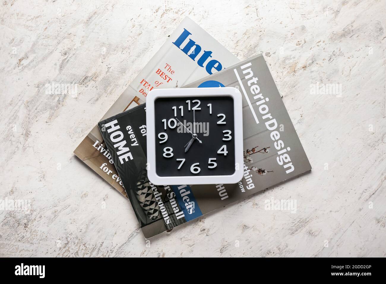 Stylish clock and magazines on grunge background Stock Photo - Alamy