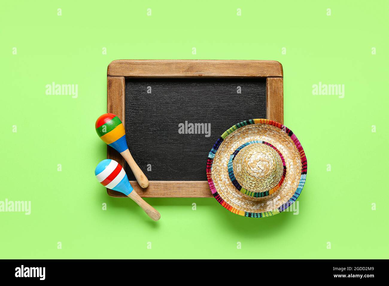 Mexican maracas, chalkboard and sombrero on color background Stock ...