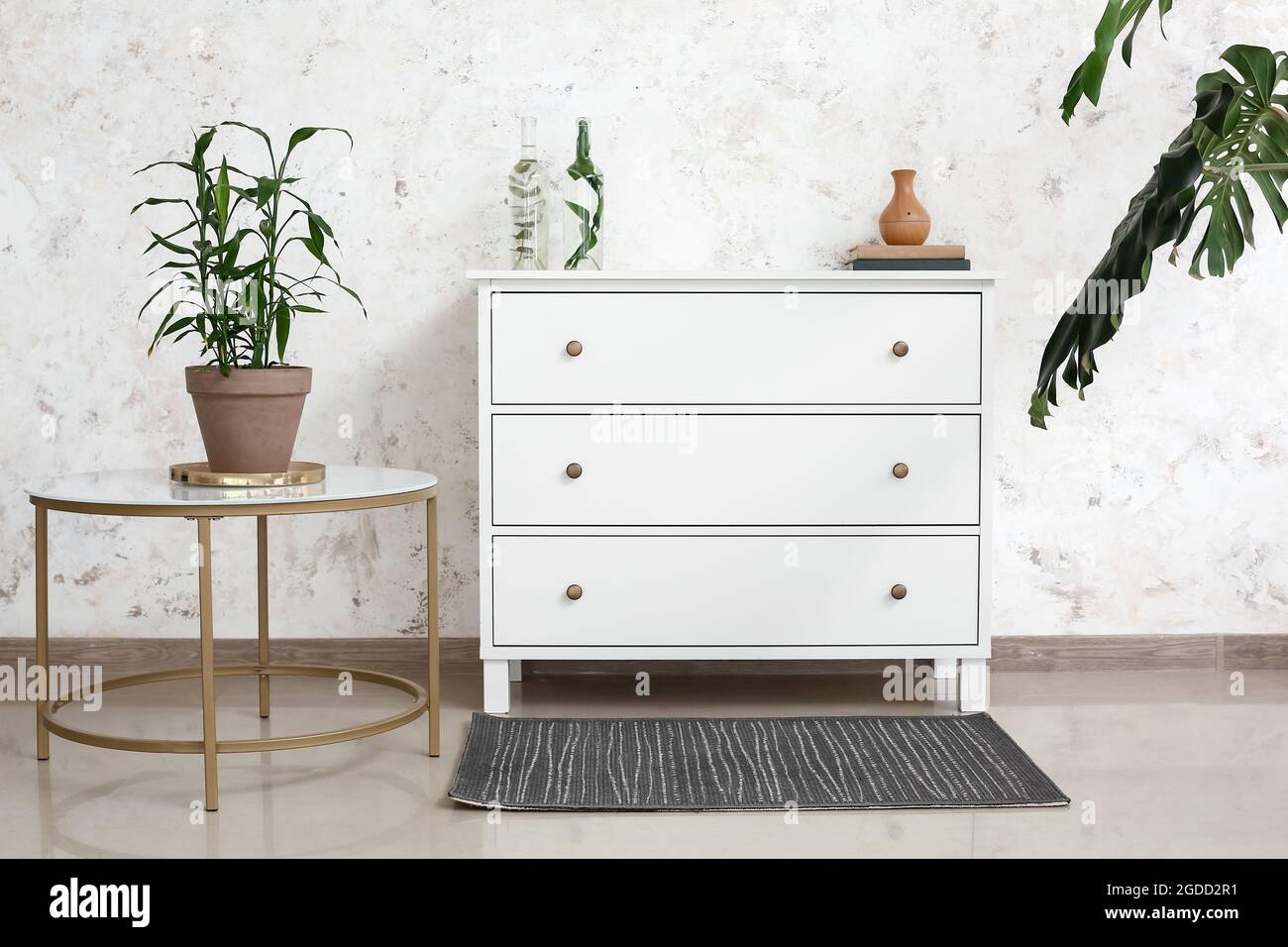 Interior of stylish living room with chest of drawers Stock Photo - Alamy