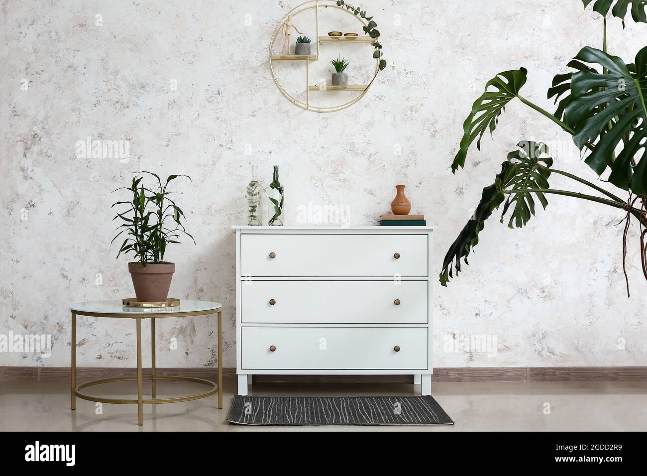 Interior of stylish living room with chest of drawers Stock Photo - Alamy